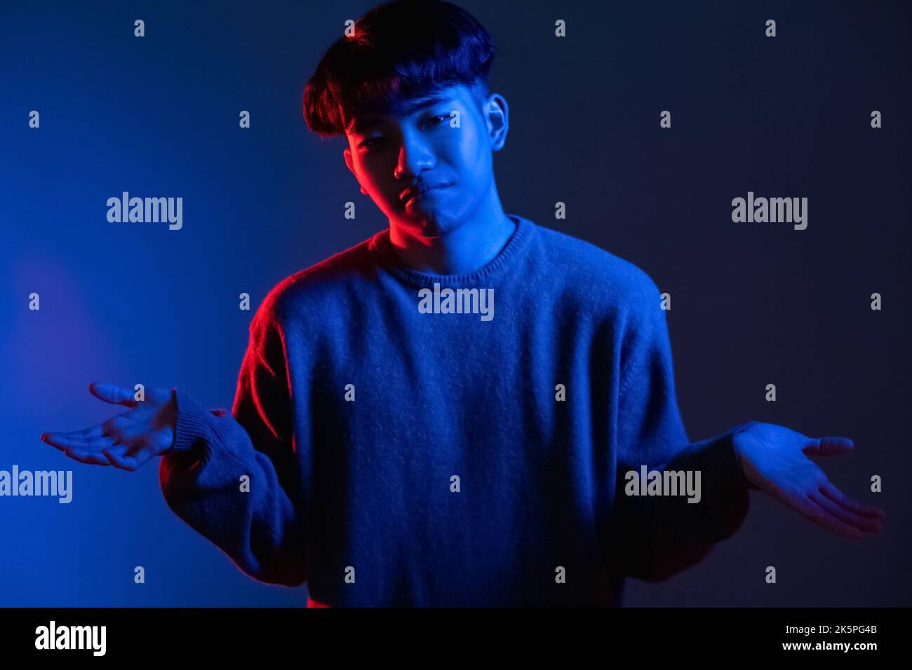 clueless man careless gesture shrugging neon light Stock Photo - Alamy