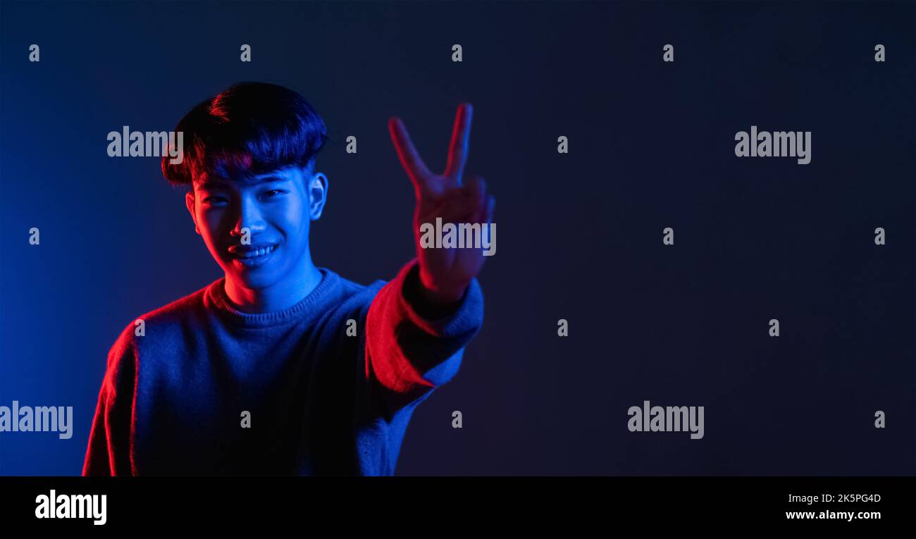 victory sign neon light banner man hand peace Stock Photo - Alamy