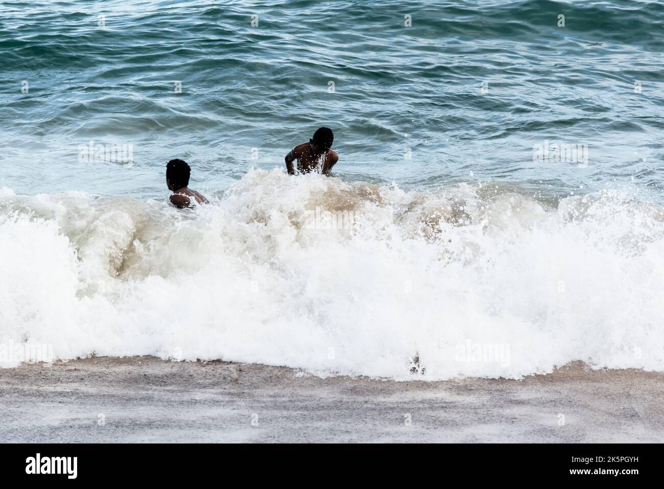 Child jumping over waves hi-res stock photography and images - Alamy