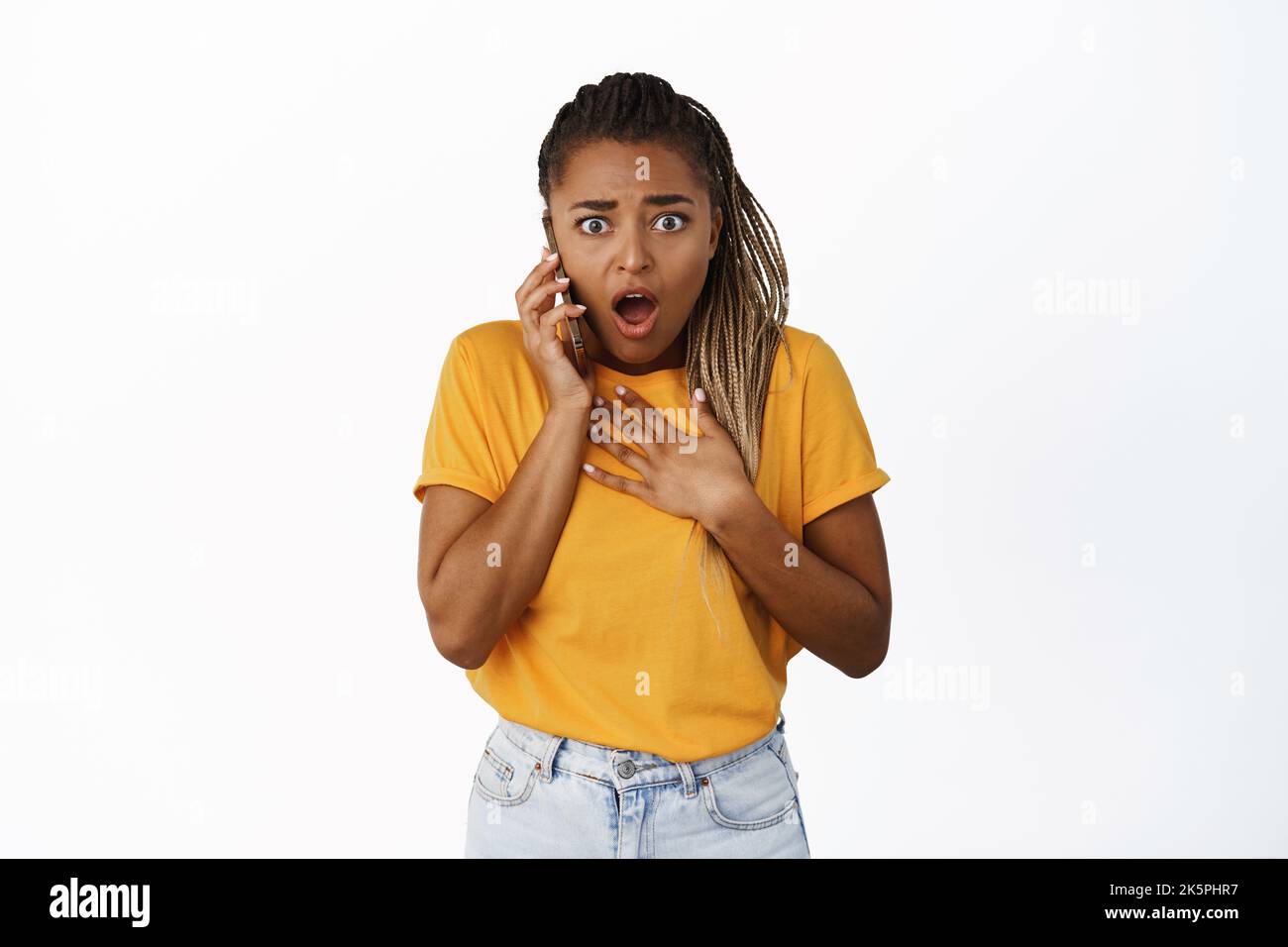 Image of black girl answer phone call and reacts shocked on bad news ...
