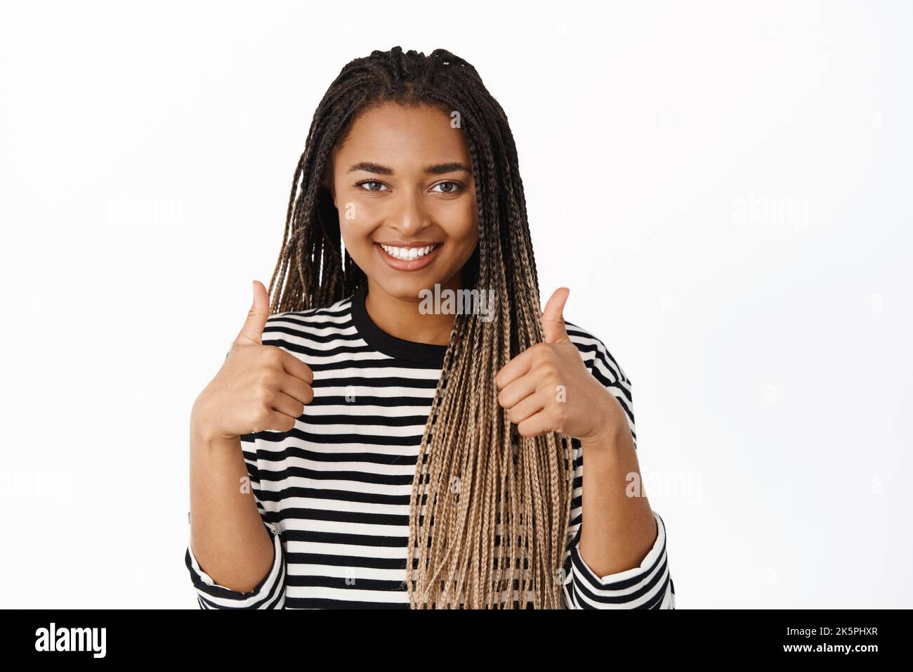 Yes, very good. Smiling black girl complimenting smth, showing thumbs up, like and agree ...