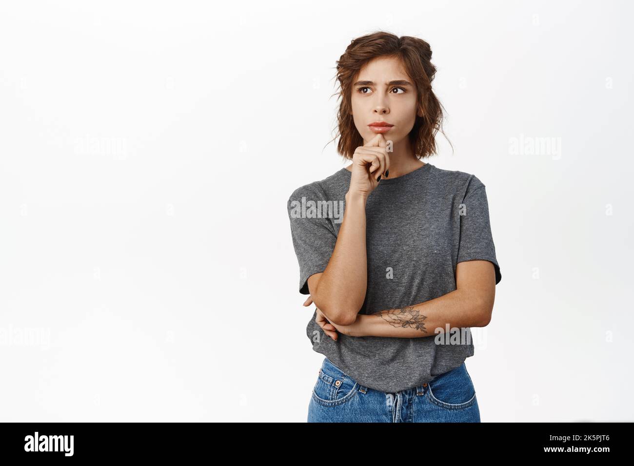 Woman with thoughtful face touching chin, thinking, making decision ...