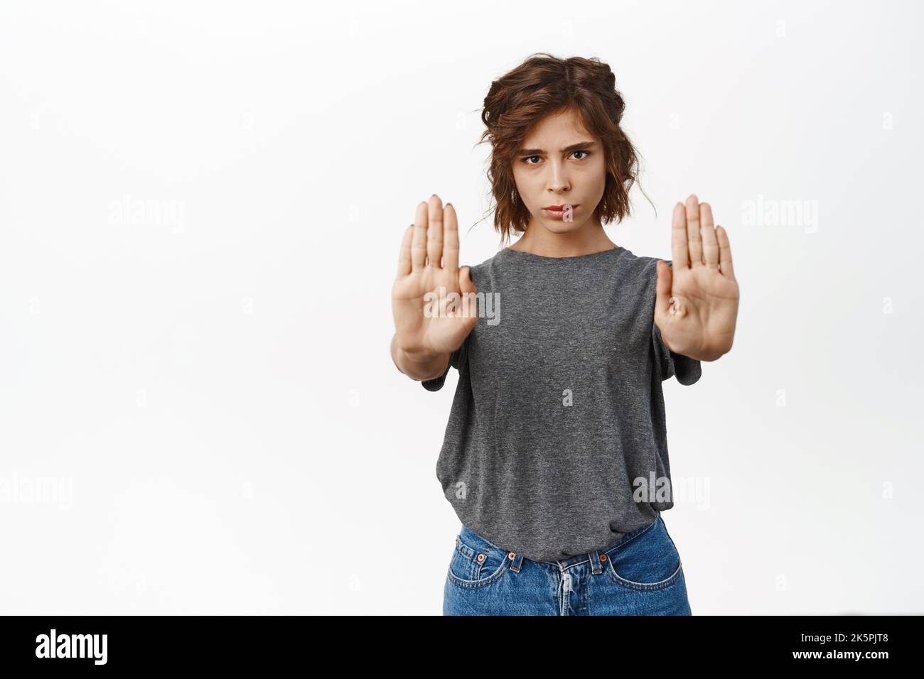Stop, enough. Serious young woman raising hands block, showing ...
