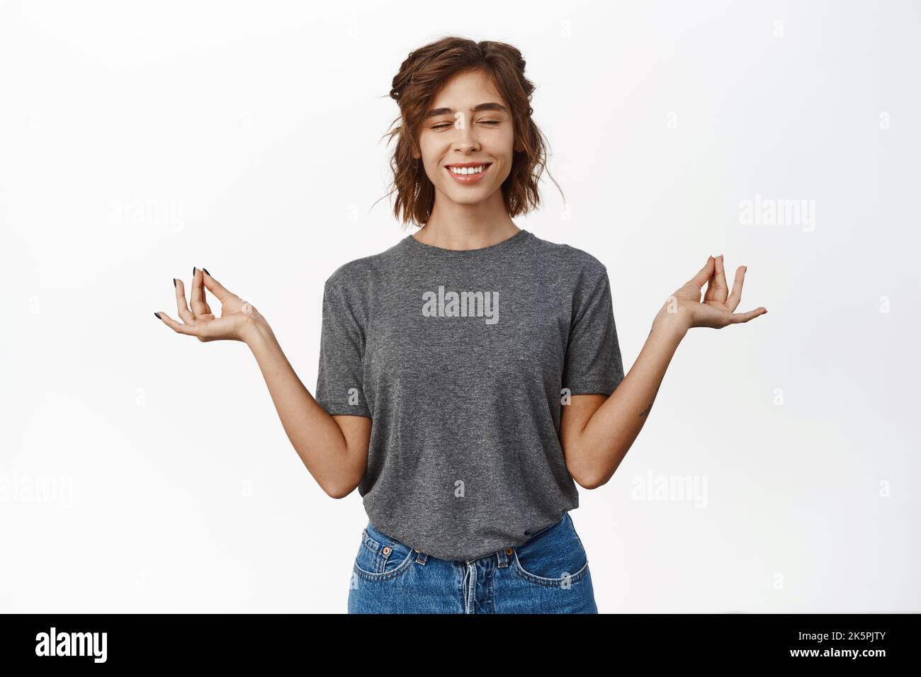 Peace and zen, smiling young woman meditating, using meditation app ...