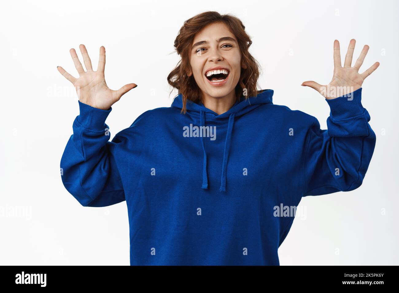 Winner, celebration. Portrait of enthusiastic young woman winning ...