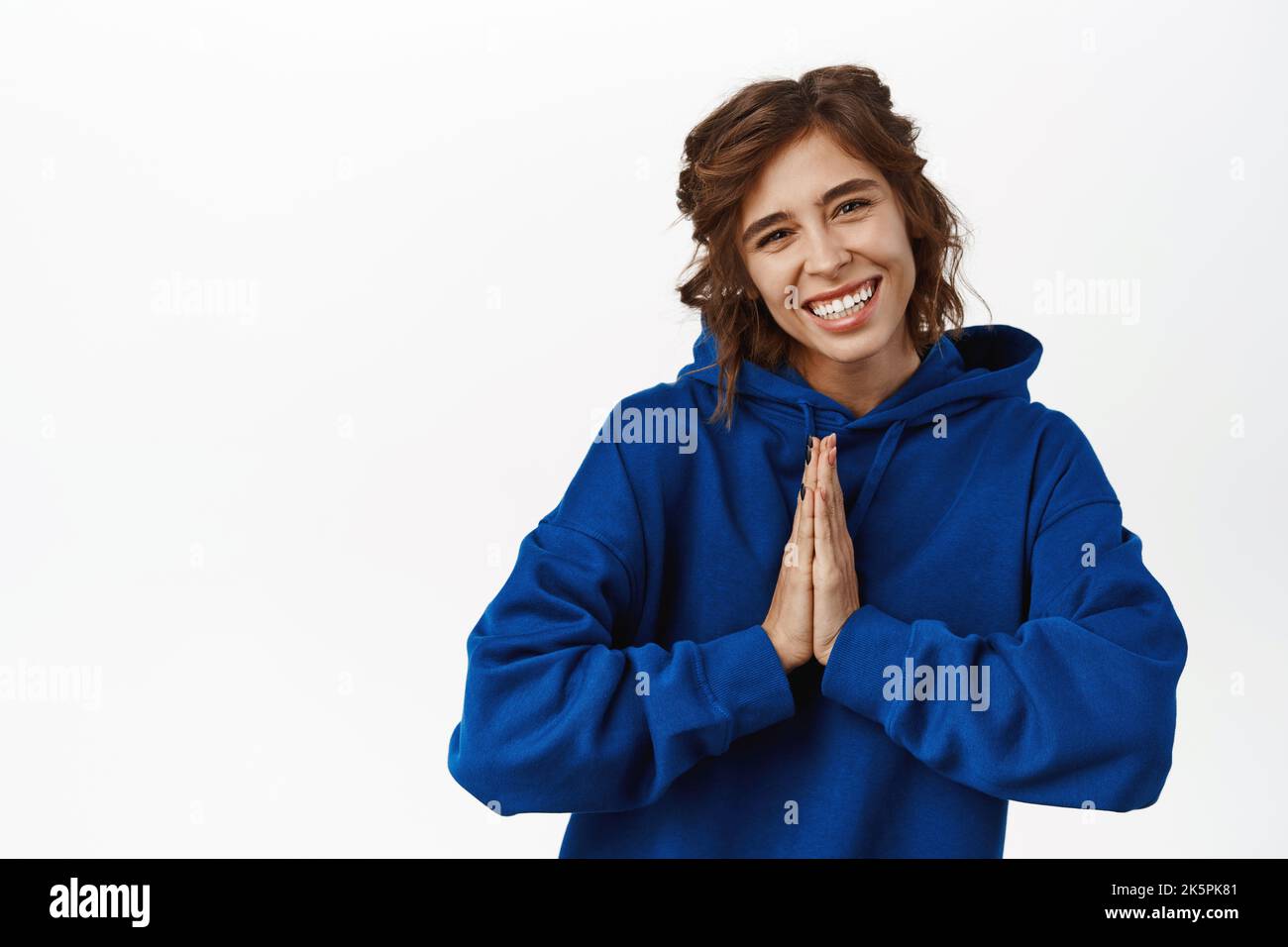 Thank you. Smiling cute brunette girl showing namaste, gratitude ...