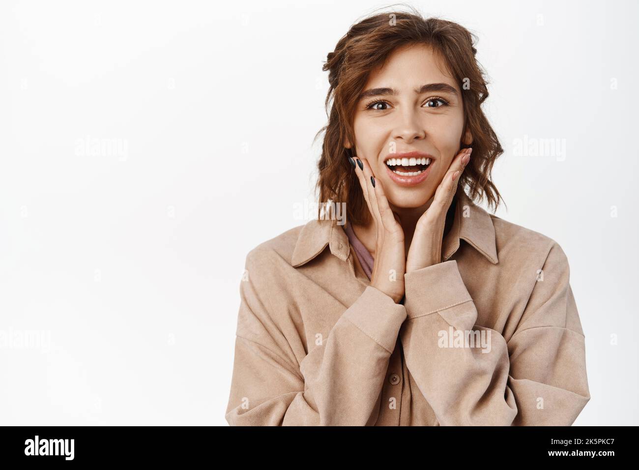 Excited young woman clap hands, looking with delight at admiration ...