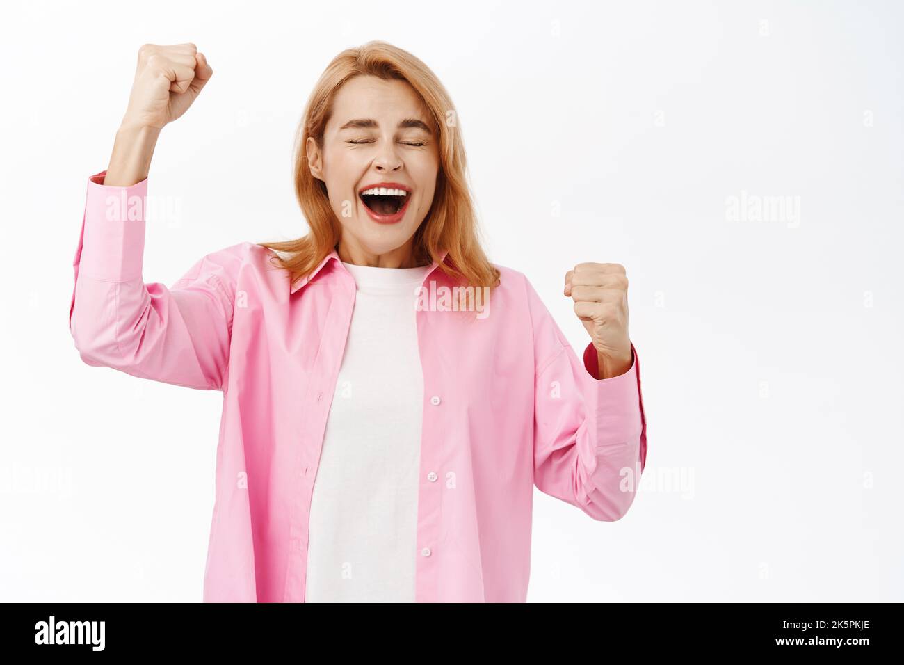 Portrait of excited happy woman, chanting and celebrating, raising ...