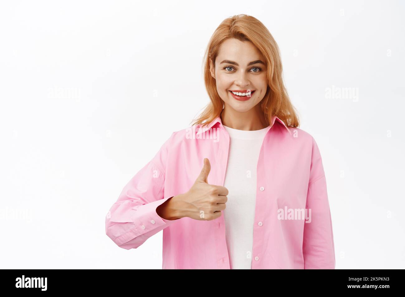 Very good, nice work. Smiling young woman showing her support with ...
