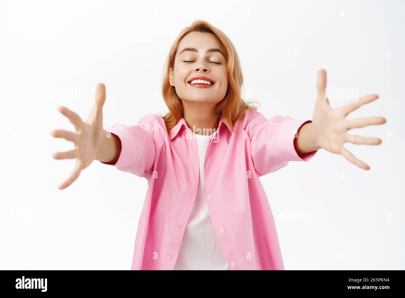 Dreamy young woman close eyes, tried to grab something, hold in her ...