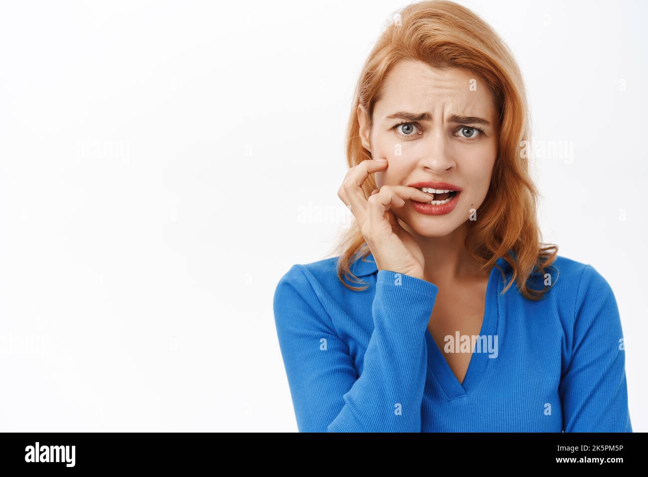 Woman biting fingers portrait hi-res stock photography and images - Alamy