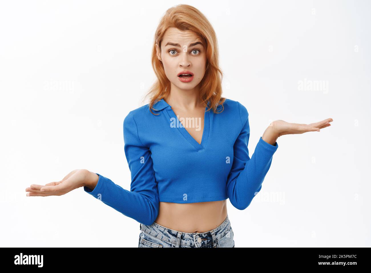 Whats wrong. Annoyed and confused woman shrugs shoulders, cant ...