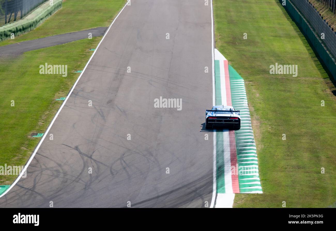 Rear view of racing car on track copy space on asphalt racetrack. Imola ...