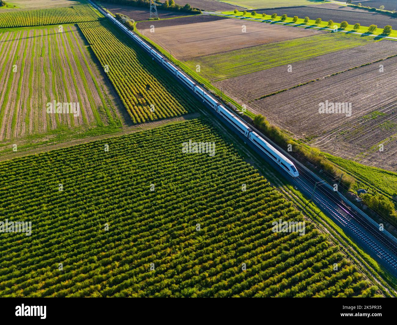 Aerial view of an ICE train on a railway track in rural area, Germany ...