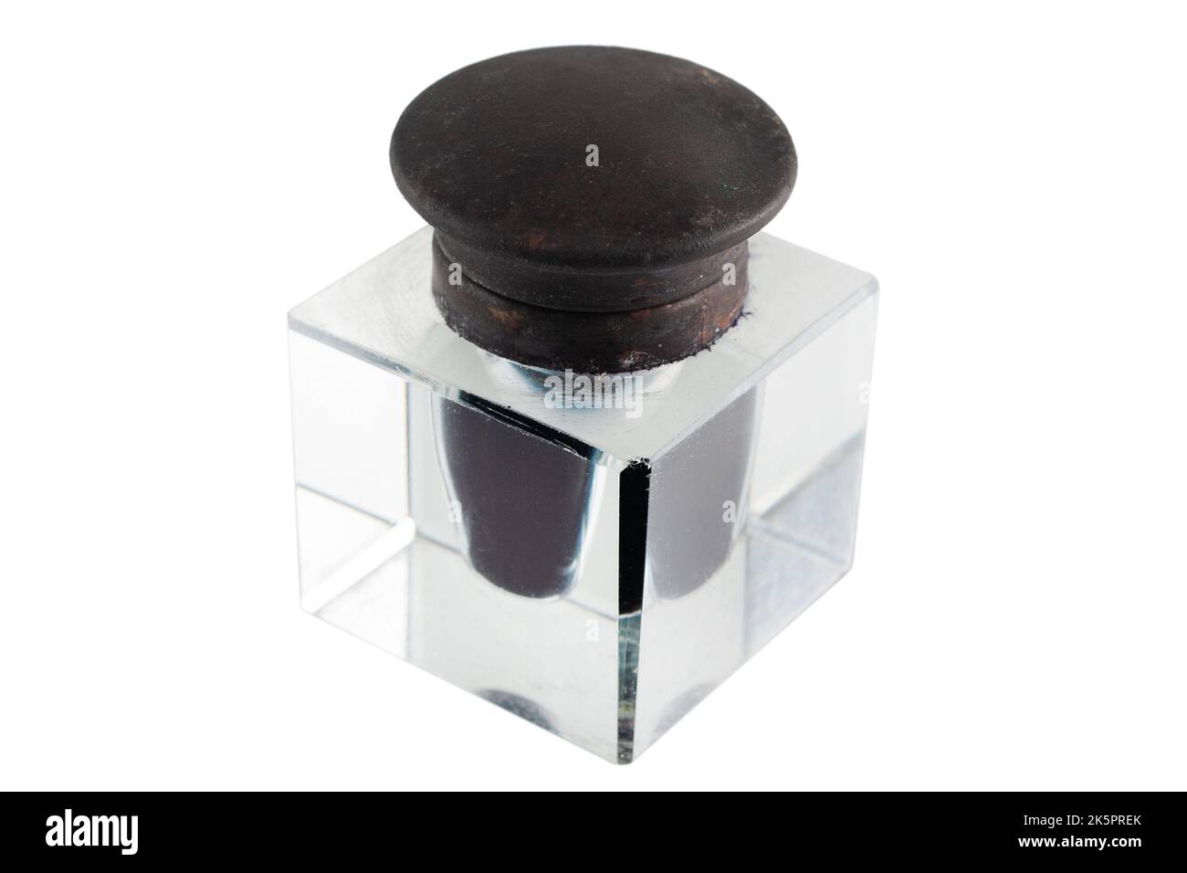 Old vintage glass inkwell with black ink isolated on white background ...