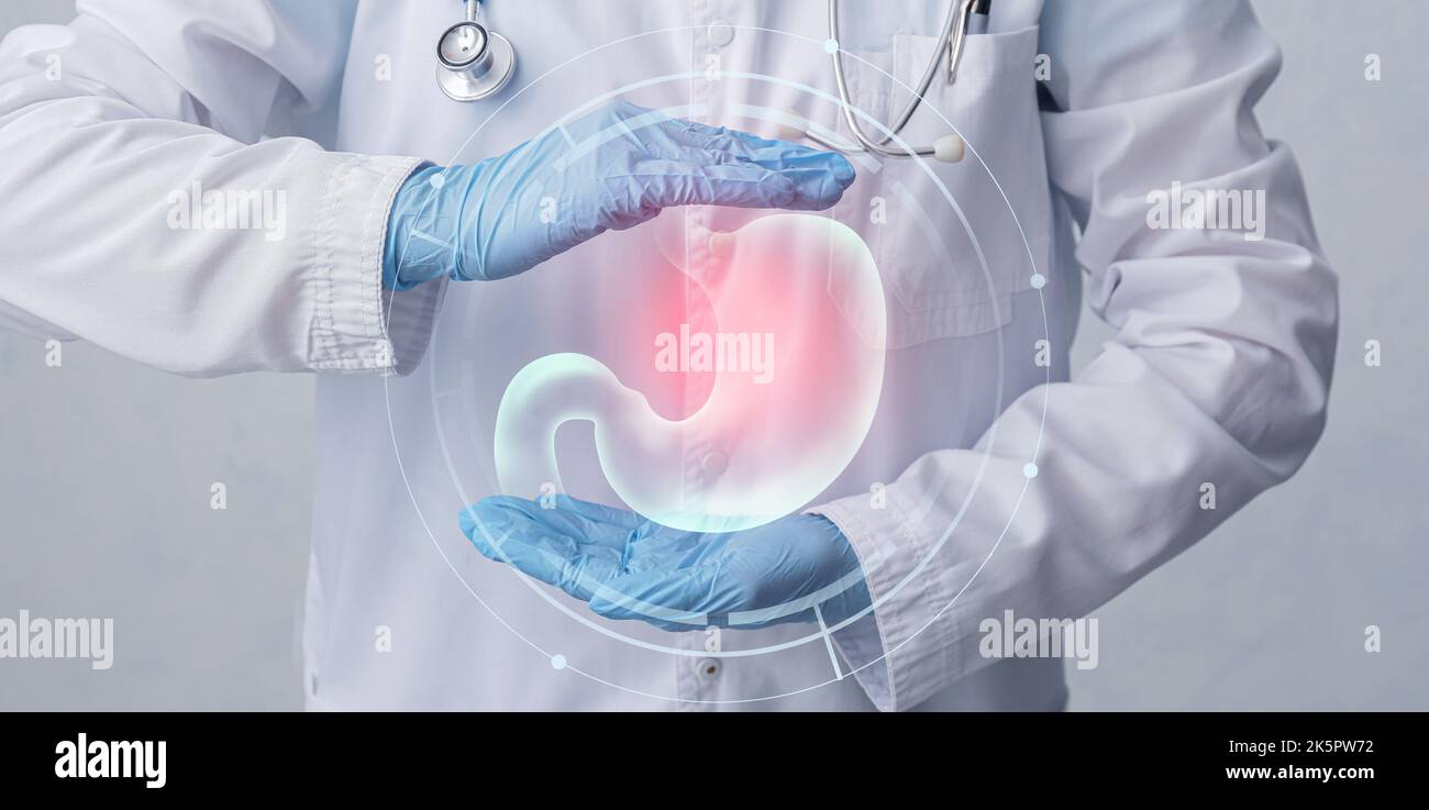 Doctor with stomach and different icons on virtual screen against grey ...
