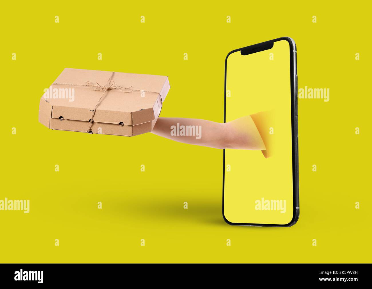 Mobile phone and hand with pizza boxes on yellow background. Food ...