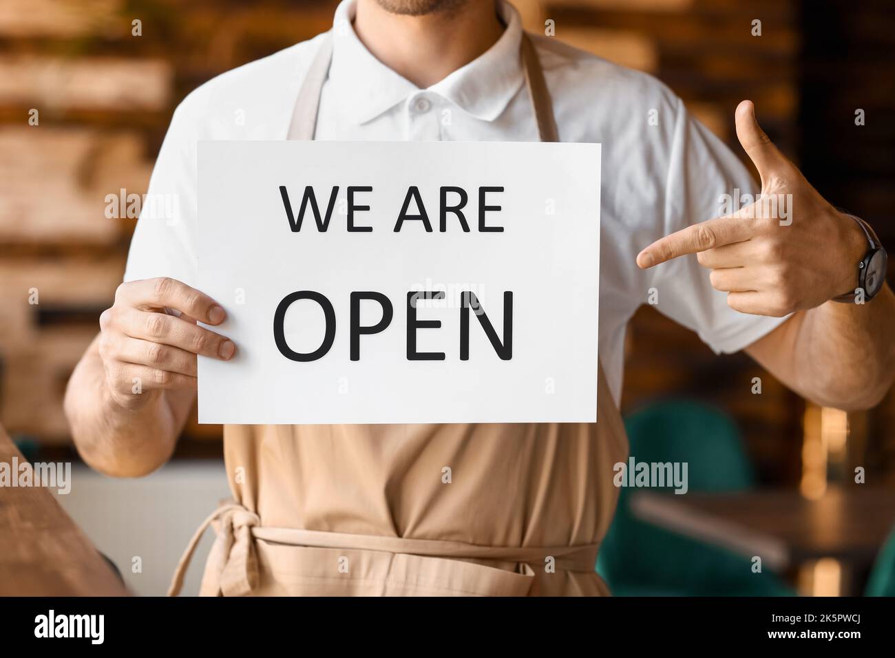 Male business owner pointing at opening sign in his cafe, closeup Stock ...