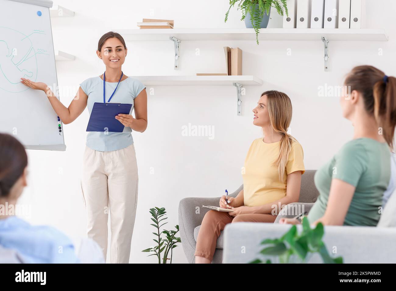 Female speaker giving course for expectant mothers in class Stock Photo ...