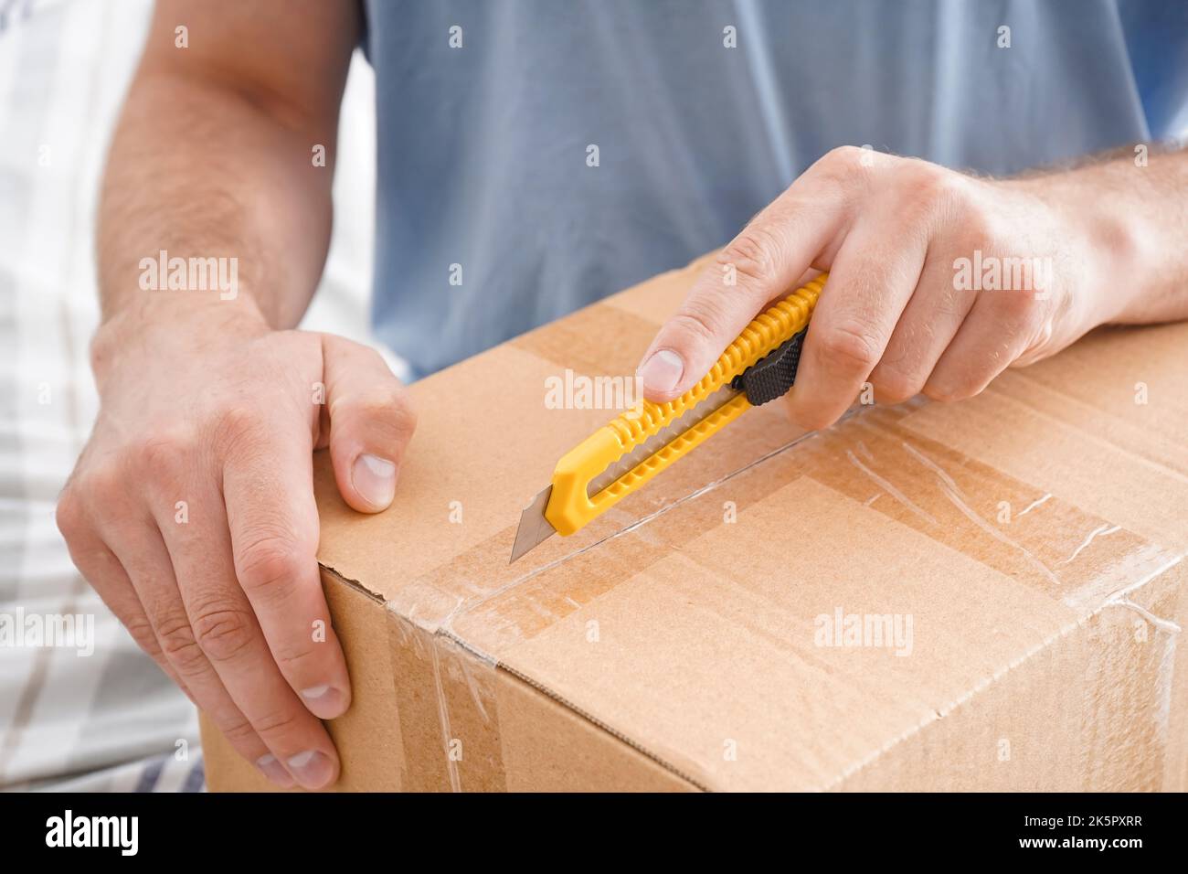 Man opening box with utility box, closeup Stock Photo - Alamy