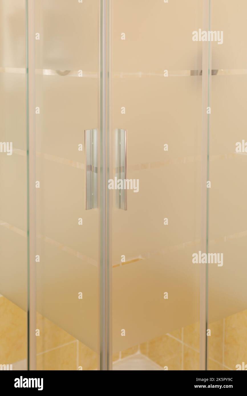 Chrome handles in a glass shower door. Modern bathroom interior Stock ...