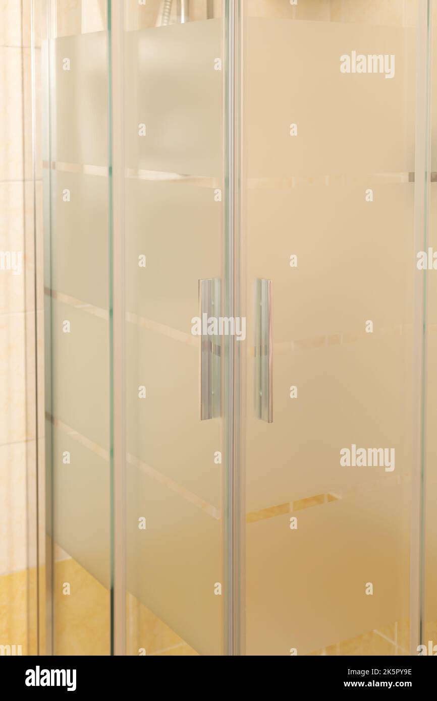 Chrome handles in a glass shower door. Modern bathroom interior Stock ...