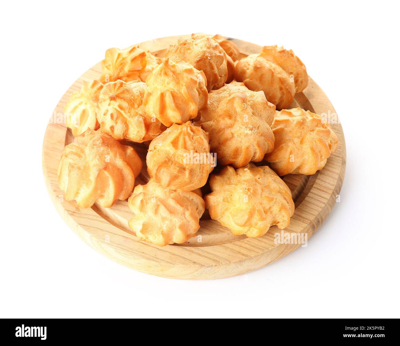 Wooden board with tasty eclairs on white background Stock Photo - Alamy