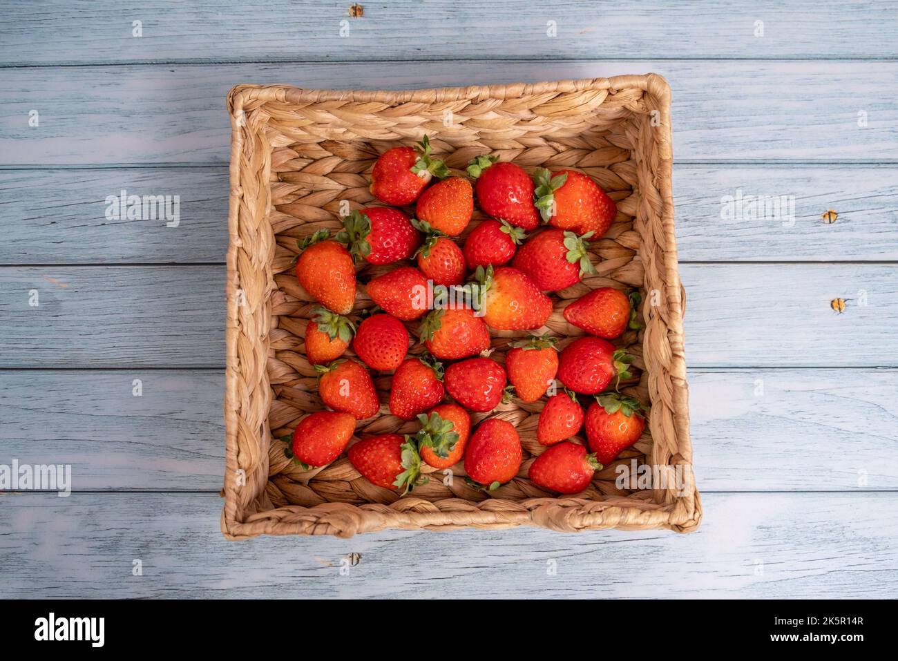 Strawberries in a basket blue wooden and white background. Strawberry ...