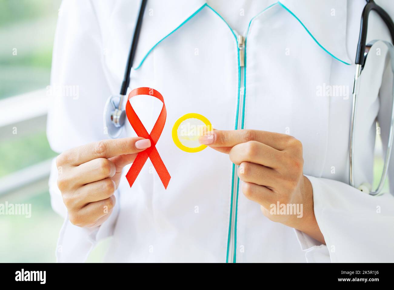 Woman hand holding red ribbon HIV, world AIDS day awareness ribbon ...