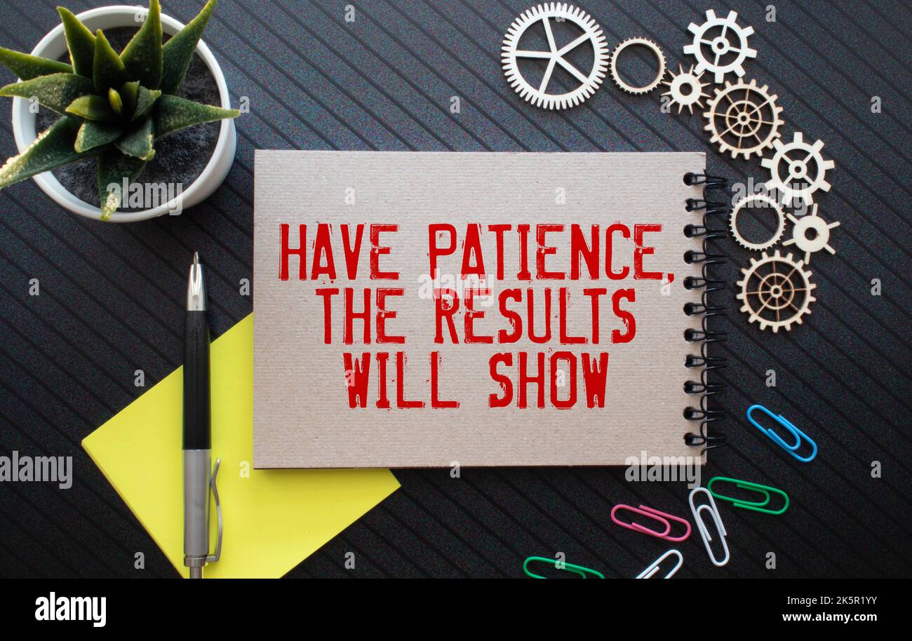 Closeup on businessman holding a card with text HAVE PATIENCE, THE ...