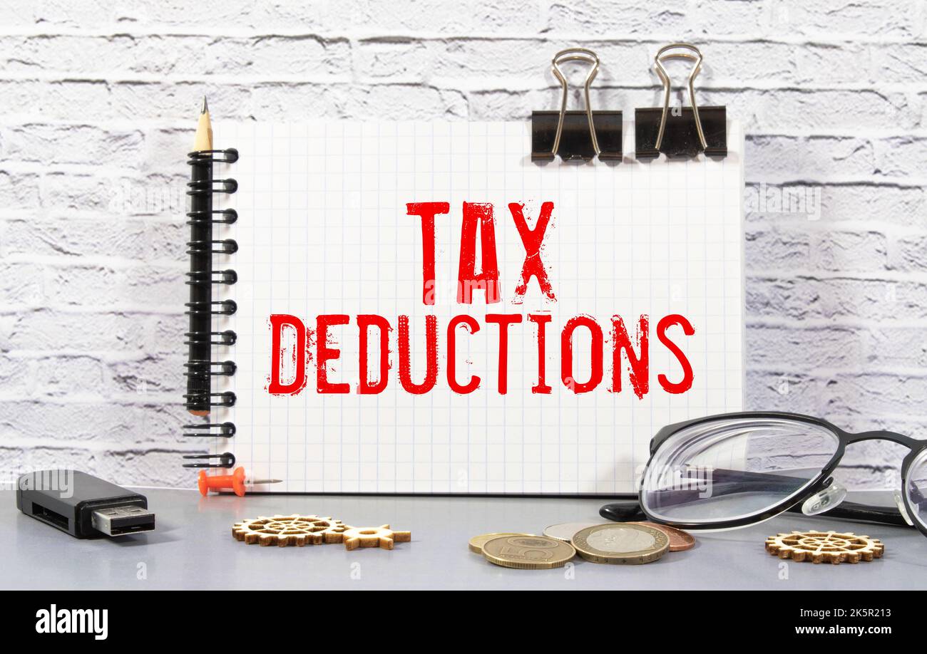 TAX DEDUCTION is written in a document on the office desk with office ...