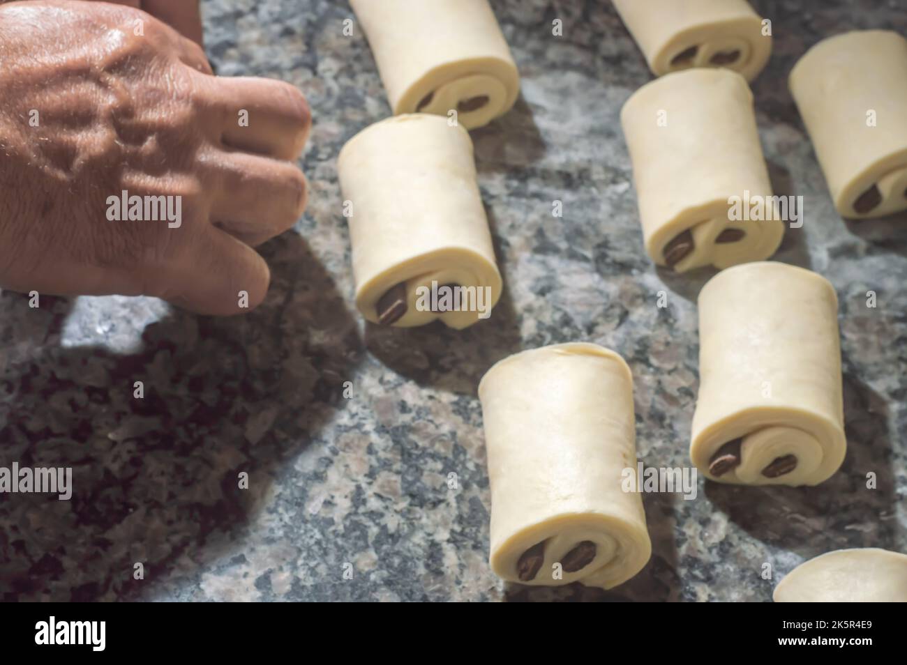 Baker making pain au chocolat before going to the oven,bakery concept ...
