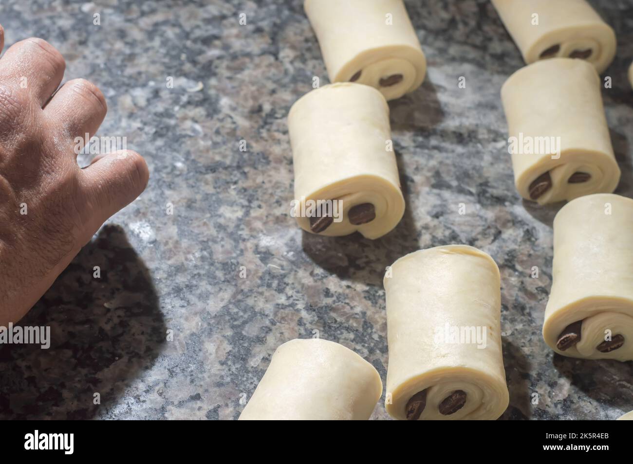 Baker making pain au chocolat before going to the oven,bakery concept ...