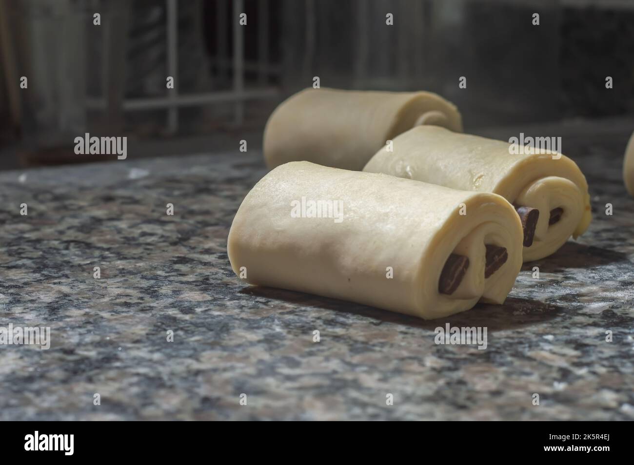 Baker making pain au chocolat before going to the oven,bakery concept ...