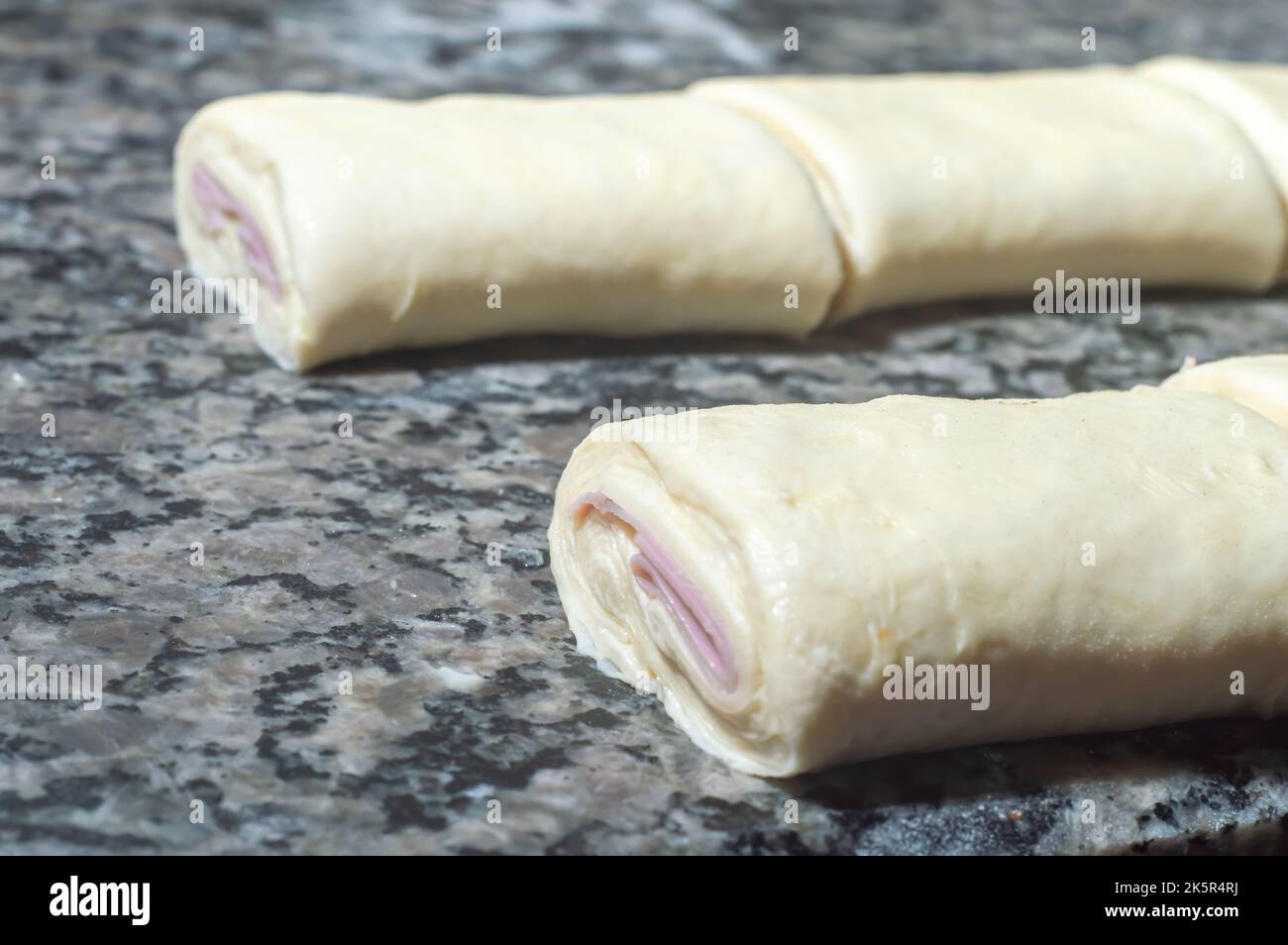 Baker making dough with ham and cheese before going to the oven,bakery ...