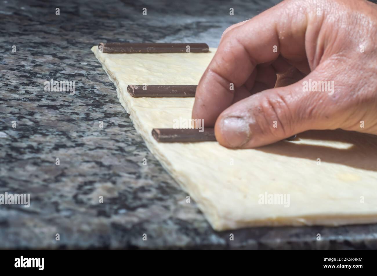 Baker making pain au chocolat before going to the oven,bakery concept ...