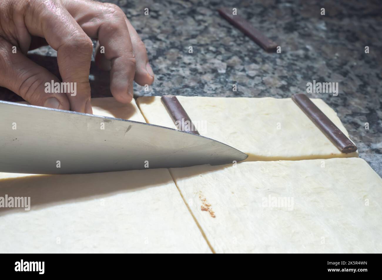 Baker making pain au chocolat before going to the oven,bakery concept ...