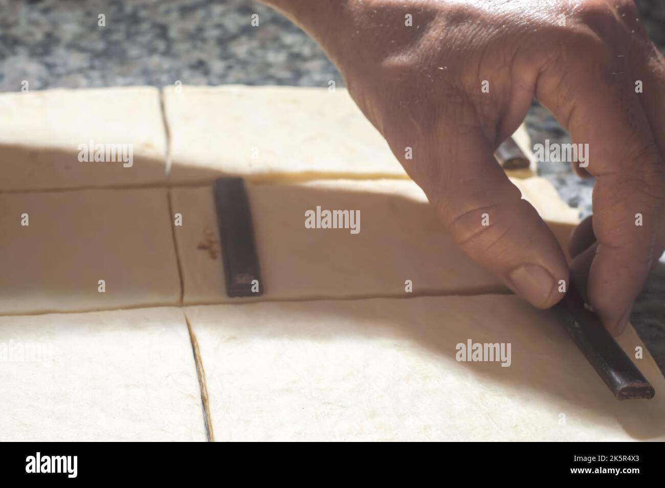 Baker making pain au chocolat before going to the oven,bakery concept ...