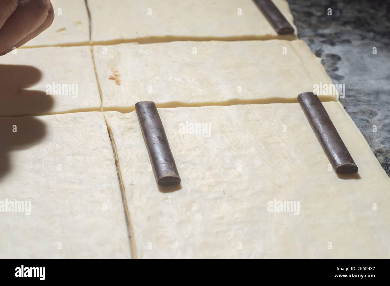 Baker making pain au chocolat before going to the oven,bakery concept ...