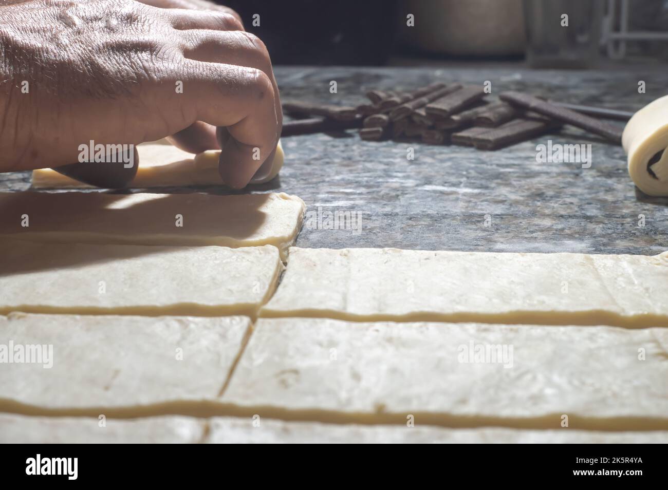 Baker making pain au chocolat before going to the oven,bakery concept ...