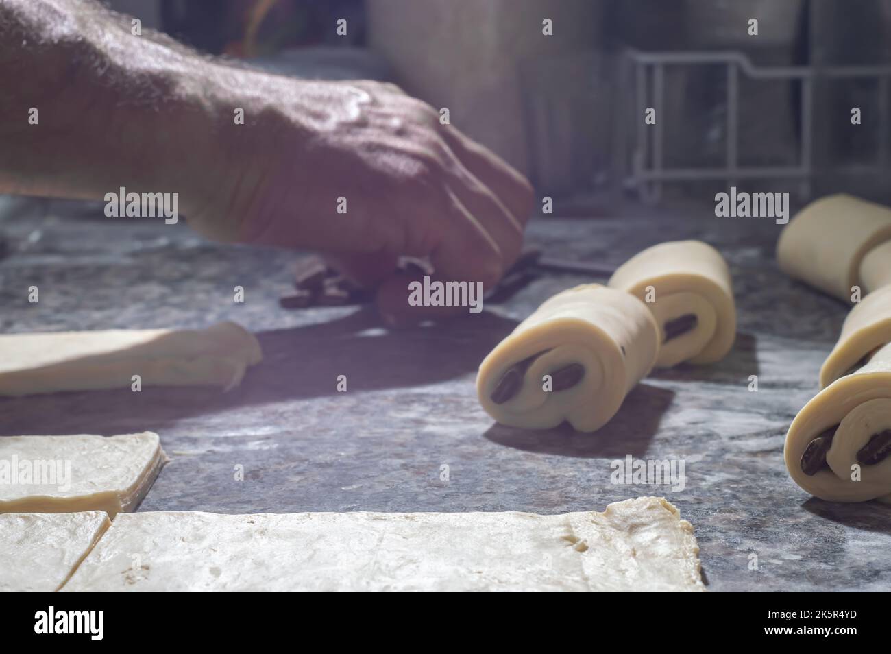 Baker making pain au chocolat before going to the oven,bakery concept ...