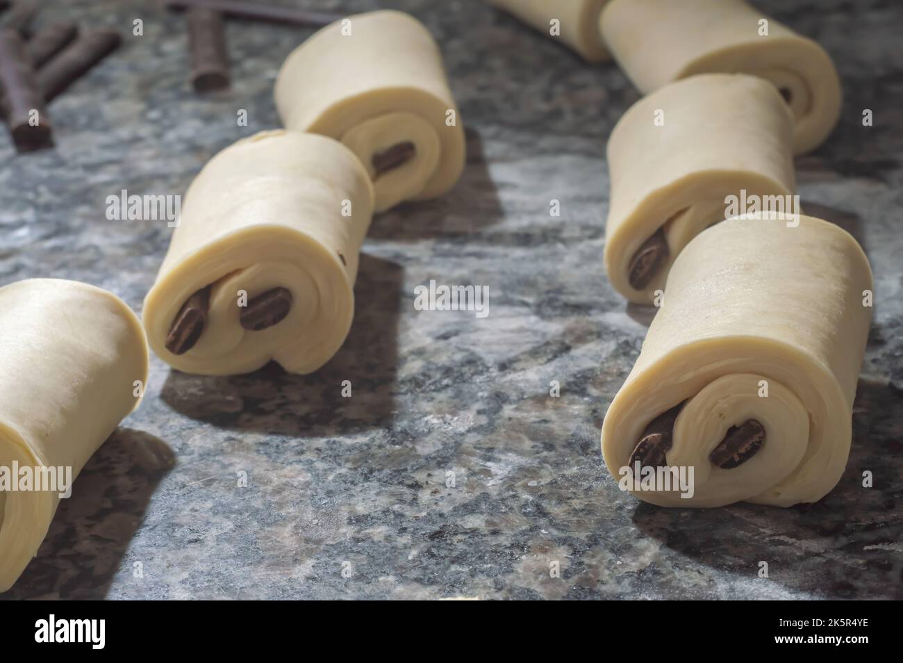 Baker making pain au chocolat before going to the oven,bakery concept ...