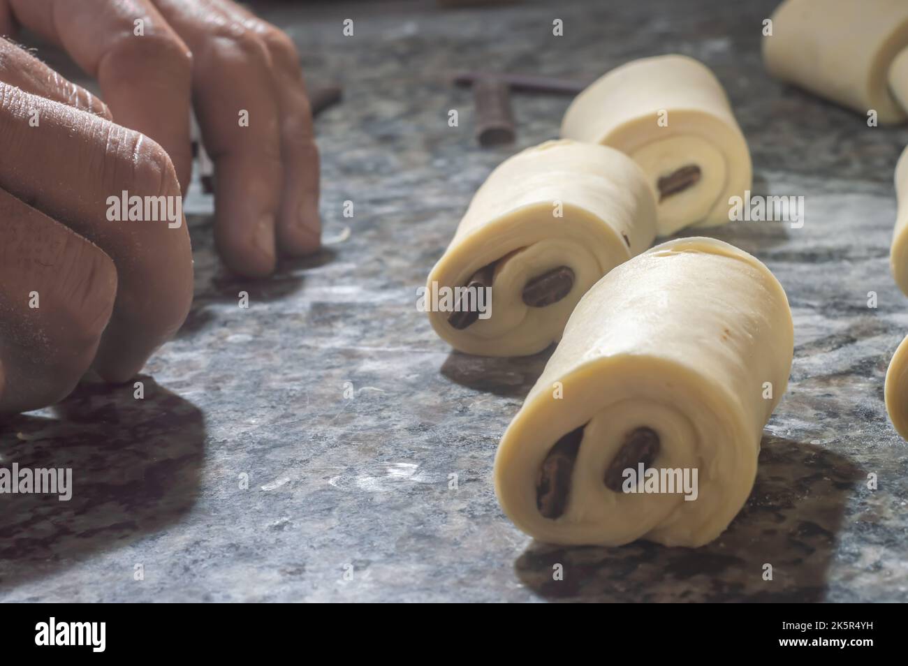 Baker making pain au chocolat before going to the oven,bakery concept ...