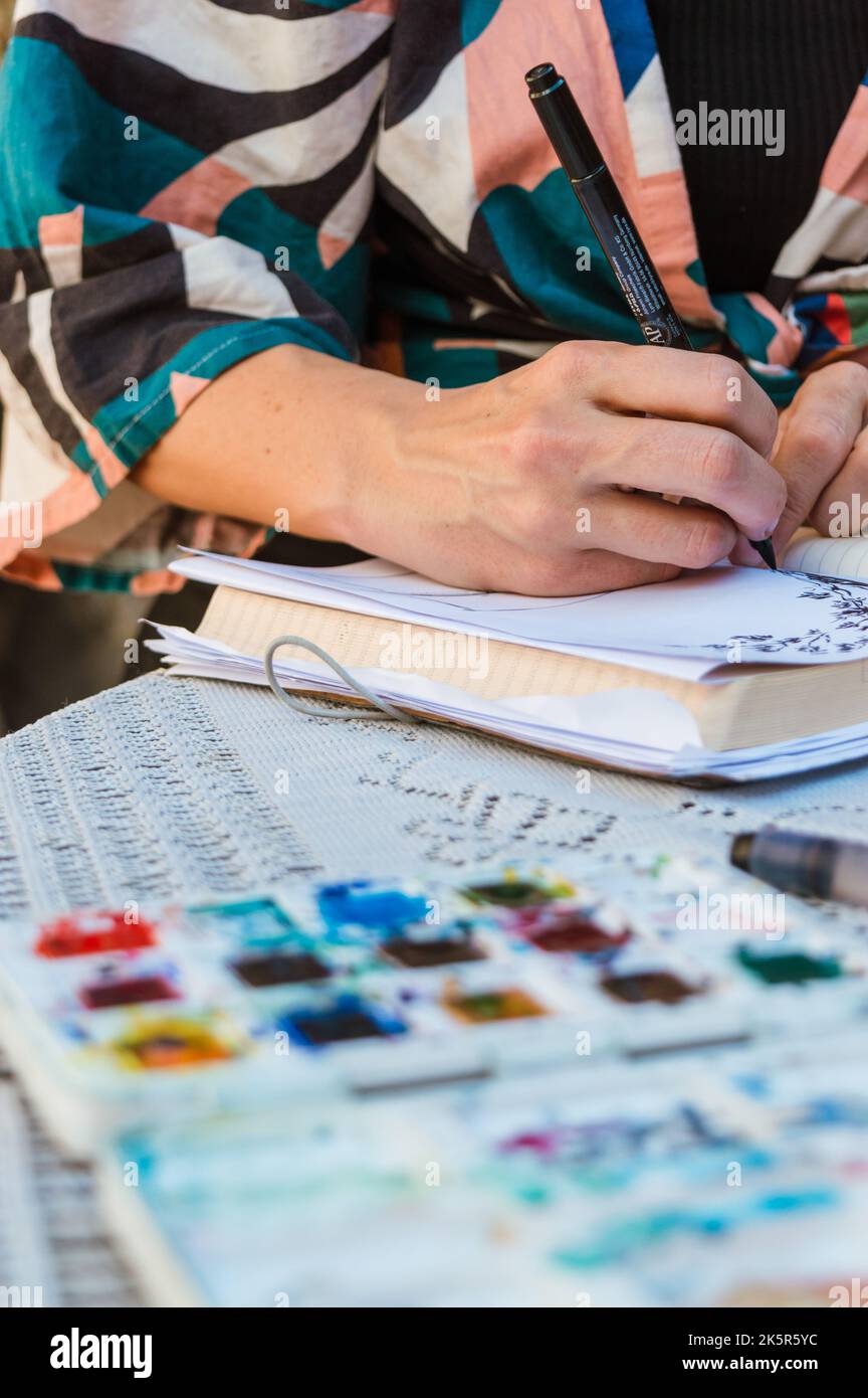vertical shot of caucasian hands of an unrecognizable woman sitting ...