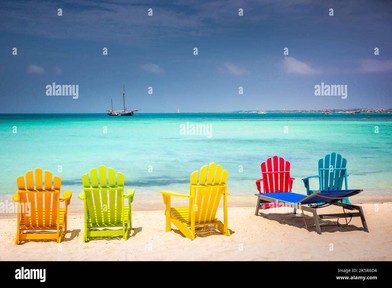 Colorful chairs in Aruba, turquoise caribbean beach with ship, Dutch ...