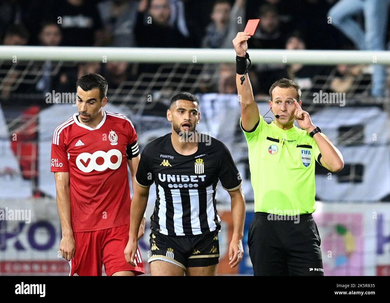 Charleroi's Adem Zorgane receives a red card from, referee Nathan ...