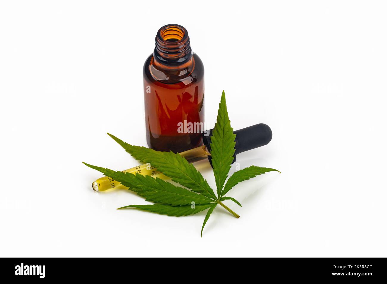 Cannabis oil hemp oil with fresh cannabis leaf on bright background ...