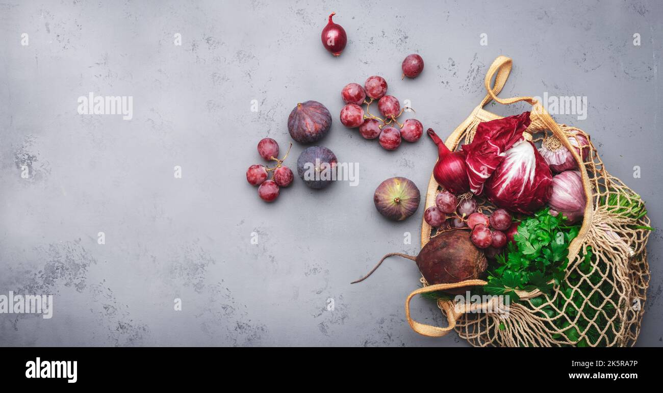 Autumn food background with purple vegetables, roots and fruits in ...