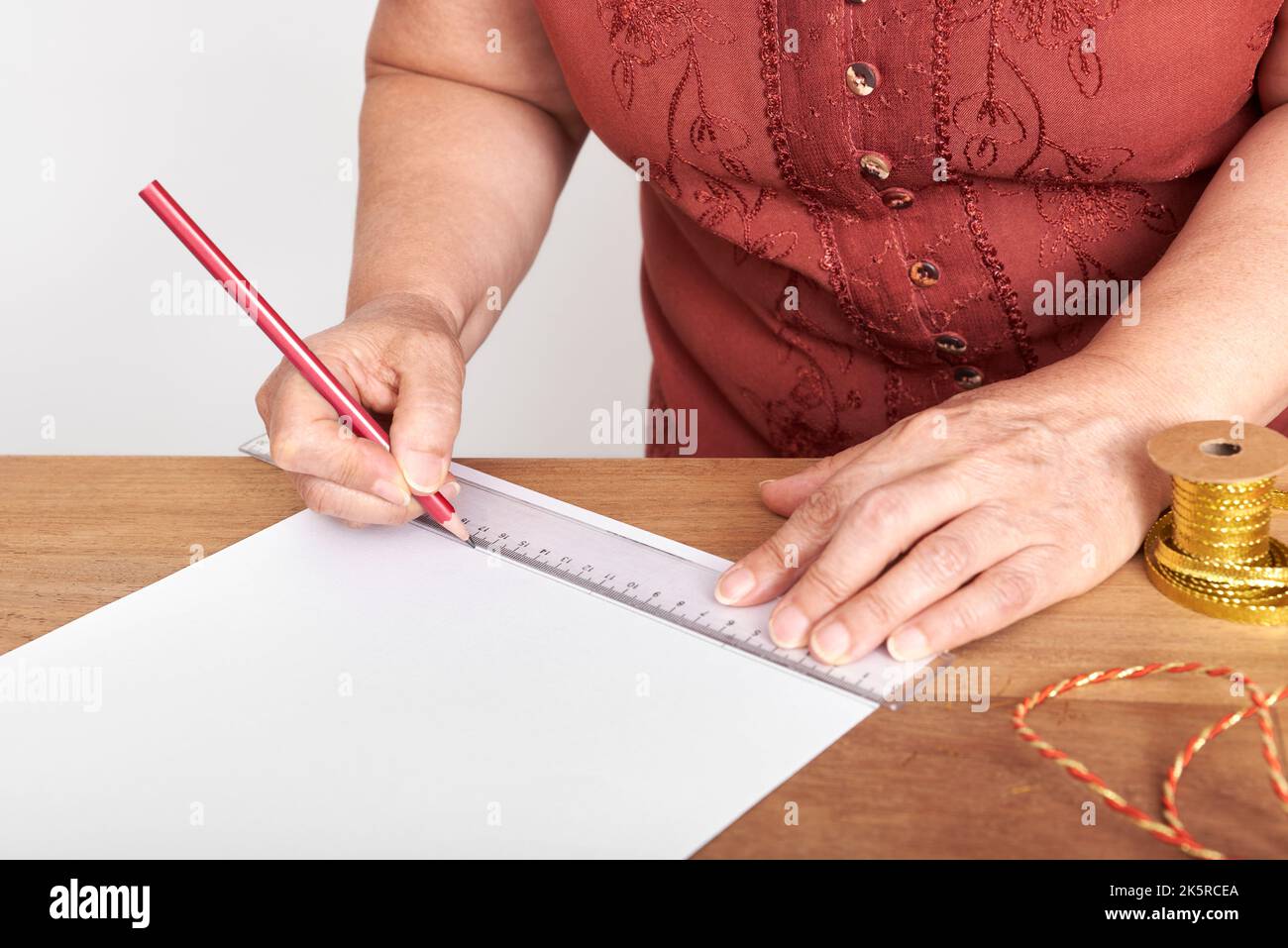 Unrecognizable mature woman measuring with a ruler, making handmade ...