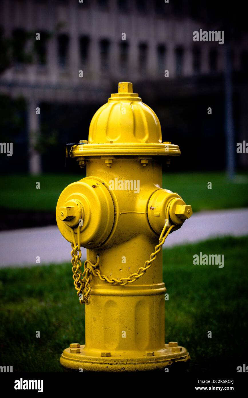 Yellow fire extinguisher in front of a building Stock Photo - Alamy